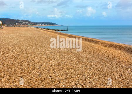 The shingle beach and promenade along West Parade with Martello Towers ...