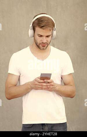 photo of man mp3 music playlist in headphones. man open mp3 music ...