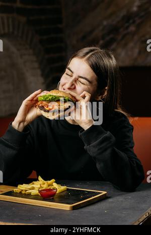 Savoring a Delicious Burger With Crispy Fries and a Refreshing Drink on ...