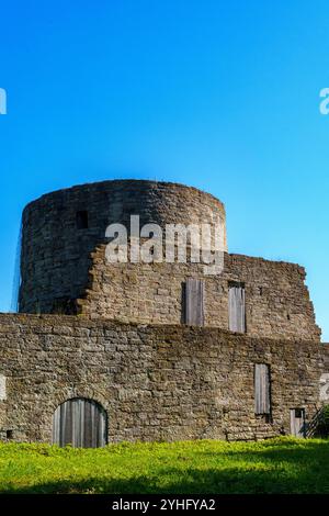 Ancient stone tower ruins standing against a clear blue sky ...