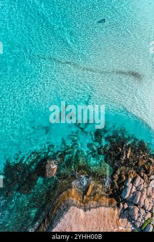 a rocky beach next to a body of water Stock Photo - Alamy