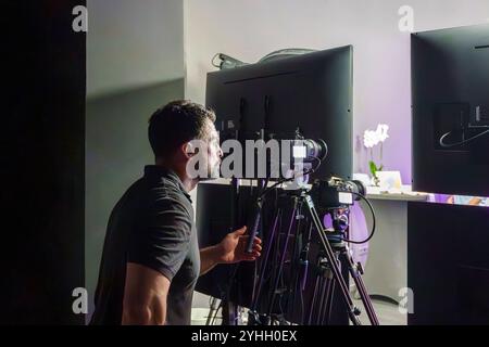 Mature Male Camera Operator Setting Up Cameras During a Live Broadcast ...
