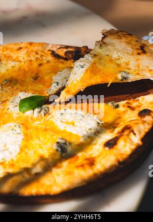 Delicious homemade cheesy pizza slice rustic round wooden board with ...