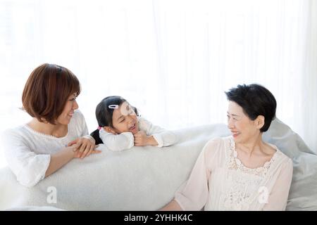 Family of three generations chatting and laughing Stock Photo - Alamy