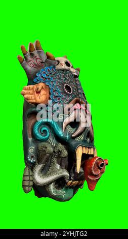 painted tiki mask with green background Stock Photo - Alamy