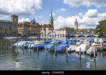 Boats at the jetty in the Limmat, towers of the Fraumuenster and St ...