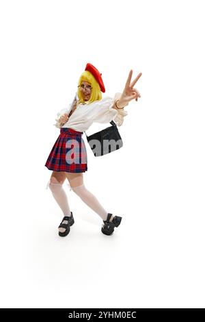 Woman with yellow wig and red beret, playing saxophone in dynamic pose ...