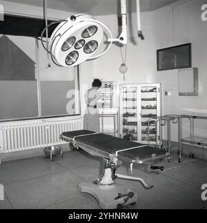 1979, historical, a female nurse at an open medical cabinet inside a ...