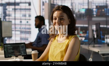 Portrait of smiling programmer creating machine learning models that ...
