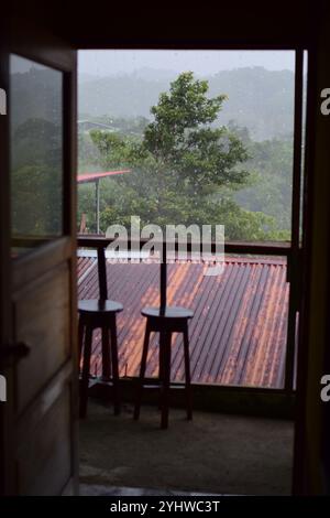Heavy rains falling in Monteverde, seen through house window Stock ...