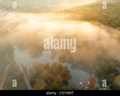 Fall forest surrounds lake with foggy surface Stock Photo - Alamy