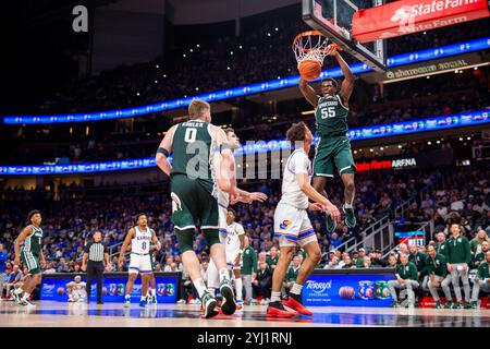 Michigan State forward Coen Carr (55) dunks over Minnesota forward ...