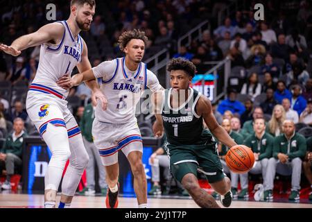 Kansas guard Zeke Mayo drives during the first half of an NCAA college ...