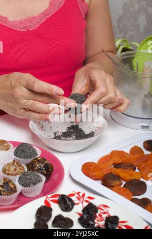Dried fruit sweets. Balls of prunes, dates and coconut. With a sprinkle ...