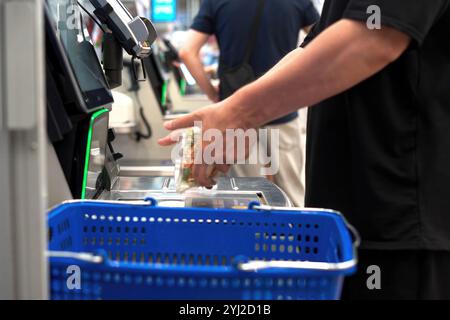 Customer scans food products at selfservice kiosk in store Stock Photo ...