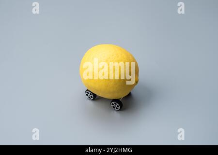 A lemon with small wheels attached to it. Lemon car, defect or ...