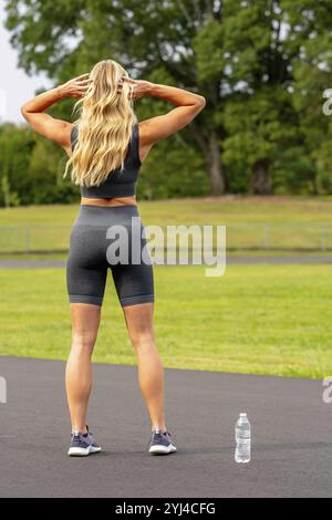 A stunning blonde woman models her trendy denim ensemble with ...