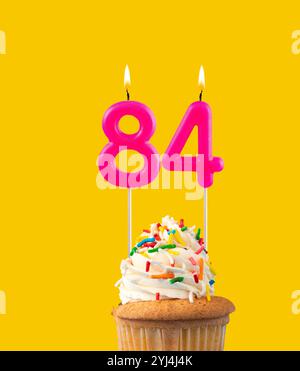 Birthday candle number 84 with cupcake - Yellow background with blue ...