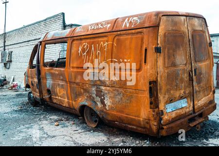 Rusty abandoned van sits decaying in an industrial junkyard, showcasing ...