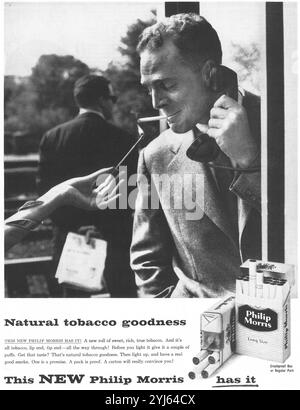 1950s BUSINESS MAN SMOKING A CIGARETTE RELAXED WITH HIS FEET UP ON THE ...