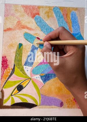 Hands with colored pencils drawing on paper. Salvador, Bahia, Brazil ...