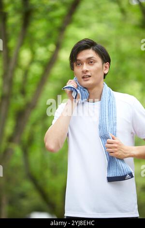 Man wiping sweat with towel Stock Photo - Alamy