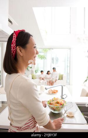 Woman cooking in kitchen, rear view Stock Photo - Alamy