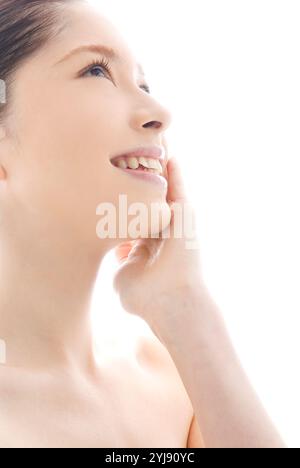 Japanese woman in her teens patting her cheek Stock Photo - Alamy