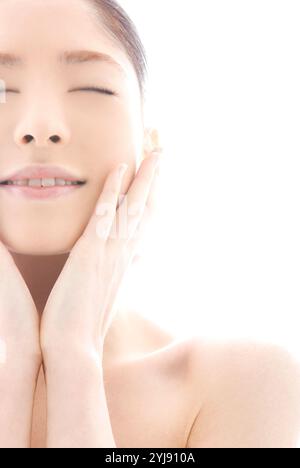 Japanese woman in her teens patting her cheek Stock Photo - Alamy