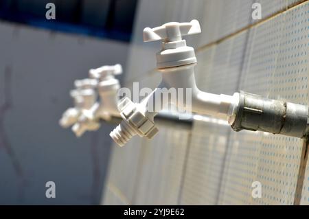 lined plastic white water faucets for ablution Stock Photo - Alamy