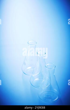 Three side-by-side triangular flasks Stock Photo - Alamy