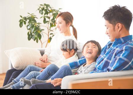 Family enjoying themselves in the living room Stock Photo - Alamy