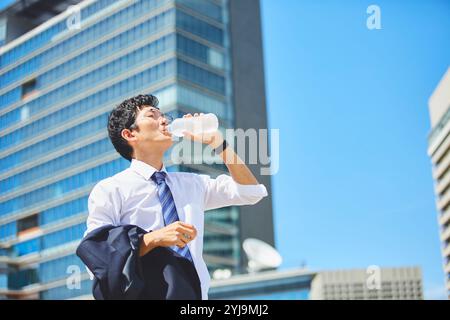 Office worker rehydrating under the blazing sun Stock Photo - Alamy
