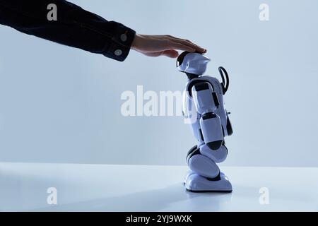 Human hand caressing robot's head Stock Photo - Alamy