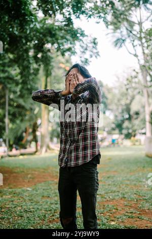 Man with displeased facial expression emotions white t-shirt studio red ...
