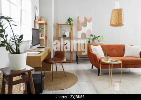 Interior of living room with programmer's workplace, sofa and shelf ...