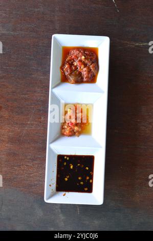 three types of chili sauce in white bowl Stock Photo - Alamy