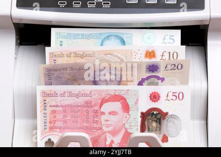 British money - pound in the counting machine Stock Photo - Alamy