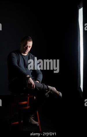 Contemplative Solitude in Dim Light Stock Photo - Alamy