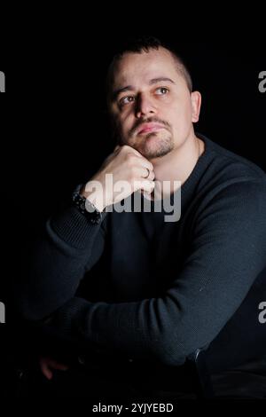 Contemplative Man in Dim Lighting Stock Photo - Alamy