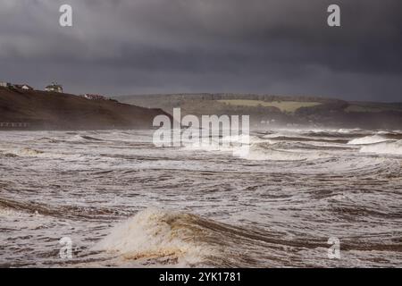 Rough seas at Whitby with misty cliffs in the background, North ...