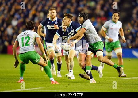 Scotland's Tom Jordan (centre) is tackled by Tonga's Siosiua Moala ...