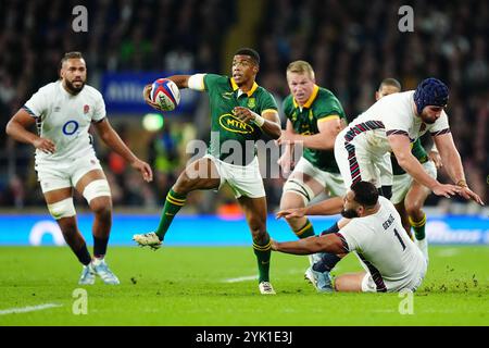 South Africa's Grant Williams, centre, kicks the ball as Australia's ...