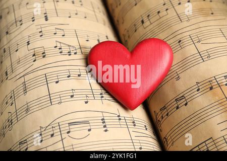 Heart figure on musical note sheets, top view Stock Photo - Alamy