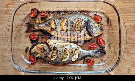 Roasted Whole Fish with Lemon Slices and Cherry Tomatoes Stock Photo ...