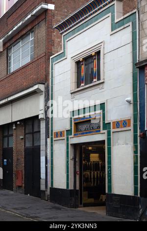 Brixton, London, UK: Entrance to Reliance Arcade at night. A shopping ...