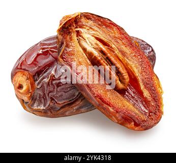 Semi-dried dates and date fruit cut in half lie on palm leaves isolated ...