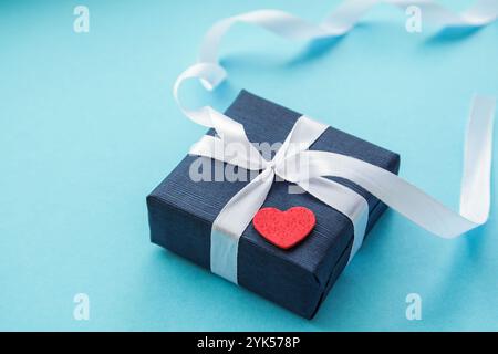 Man with light blue ribbon on color background with space for text ...