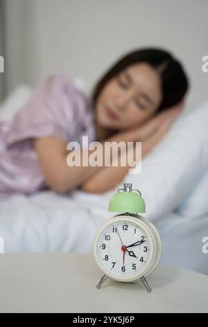 Woman with alarm clock at home, closeup. Daylight saving time Stock ...