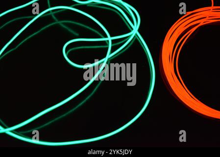 Unusual glowing blue and red thread, twisting wire, structural and ...